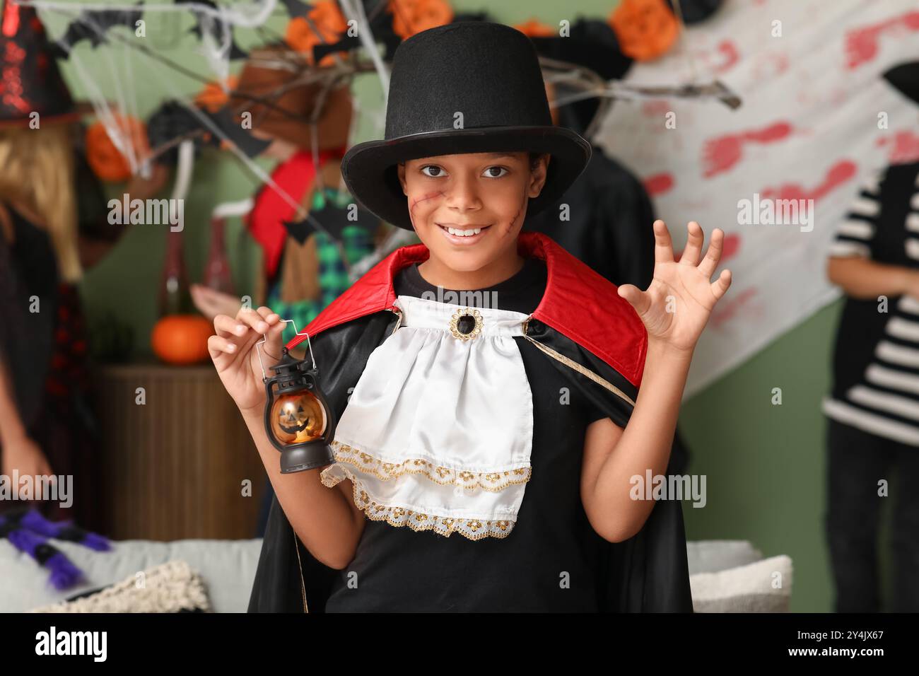 Cute happy African-American boy dressed as Dracula for Halloween party ...
