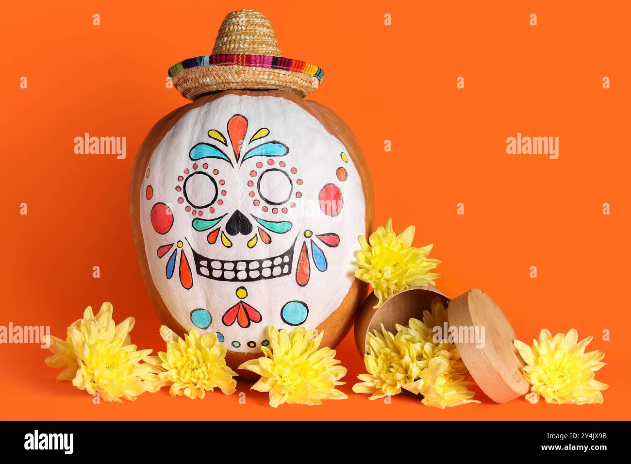 Pumpkin with painted skull, mini sombrero and beautiful flowers on ...