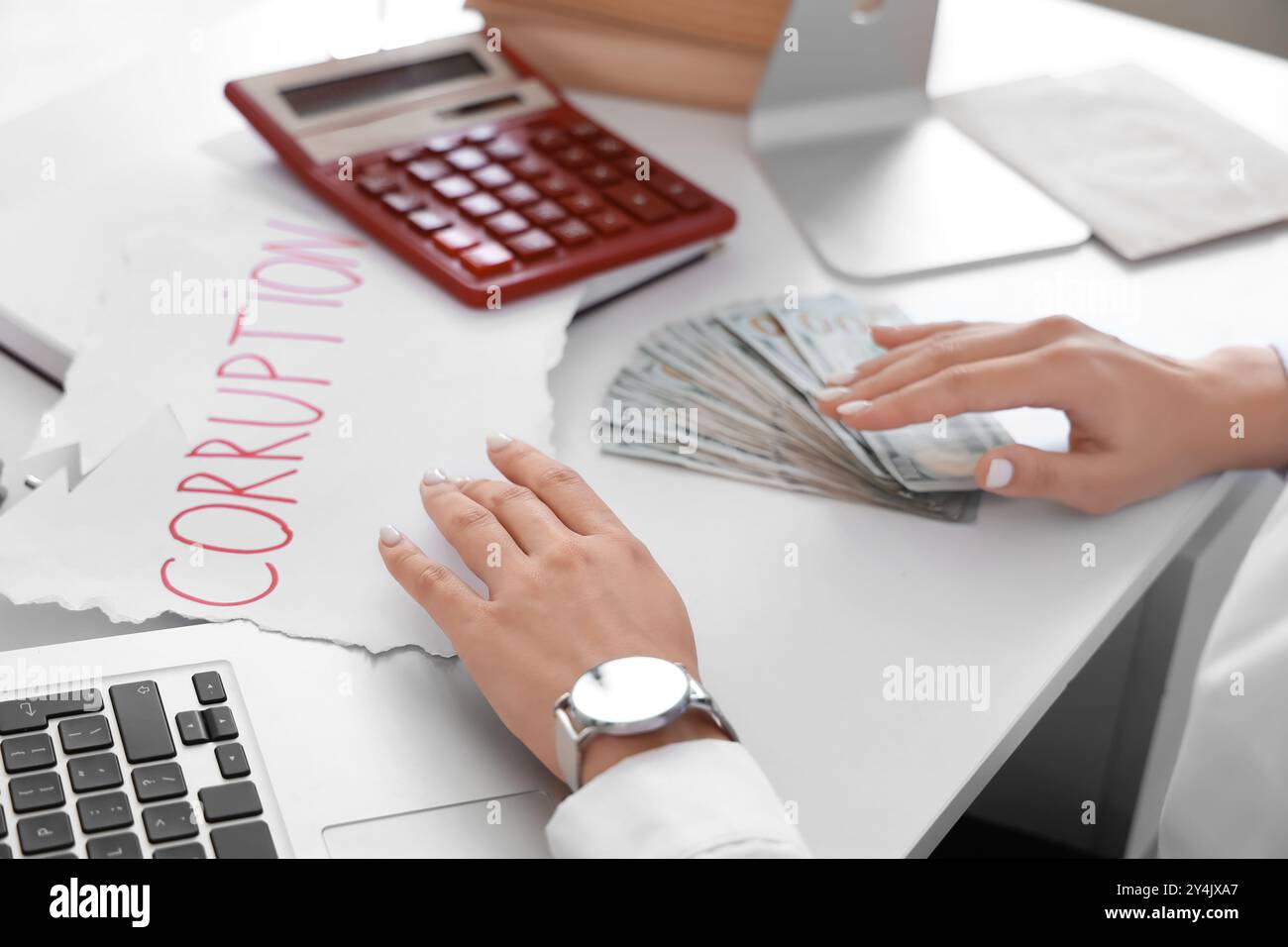 Female teacher with bribe on table in classroom, closeup. Corruption ...