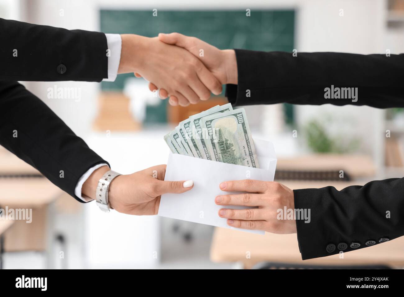 Female teacher taking bribe in classroom, closeup. Corruption concept ...