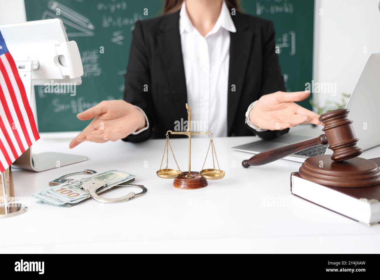 Female teacher with bribe, justice scales and judge's gavel on table in ...