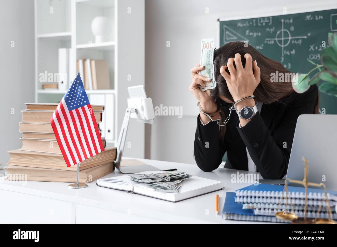 Handcuffed female teacher with bribe at table in classroom. Corruption ...