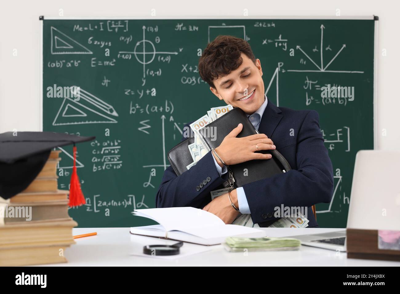 Handcuffed male teacher with briefcase and bribe in classroom ...