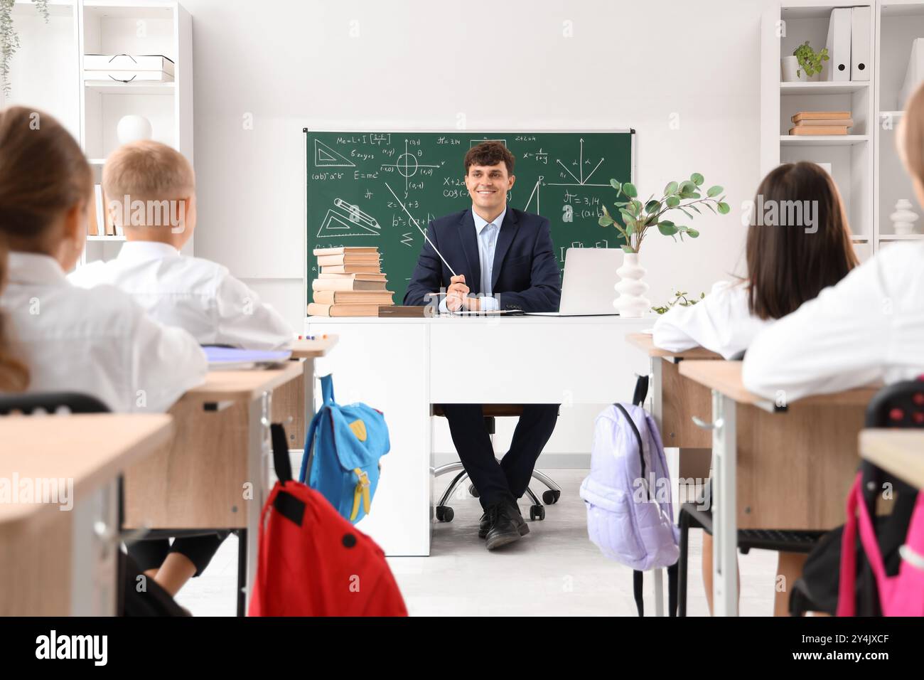 Male teacher conducting Math to pupils in classroom Stock Photo - Alamy