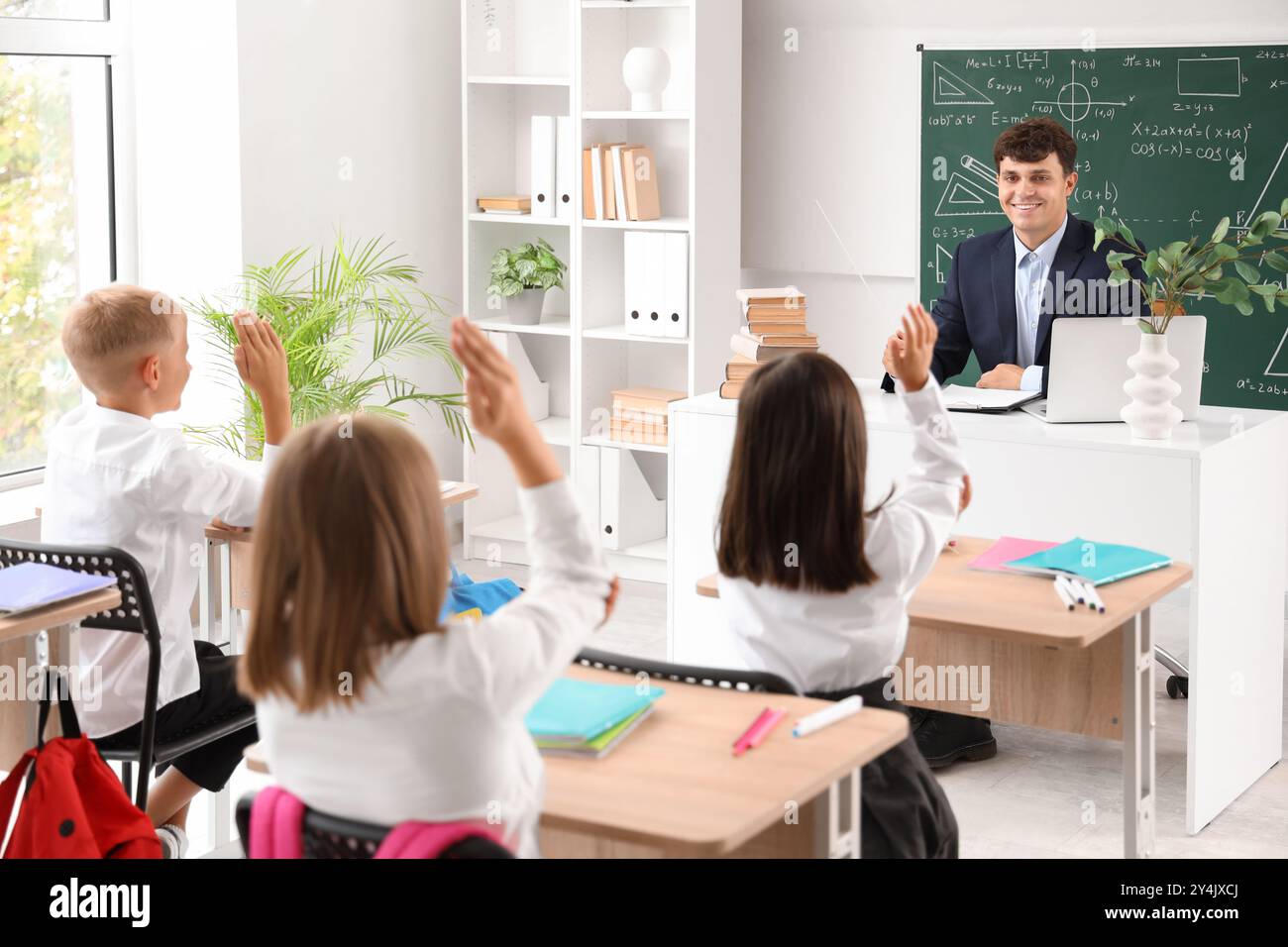 Male teacher conducting Math to pupils in classroom Stock Photo - Alamy