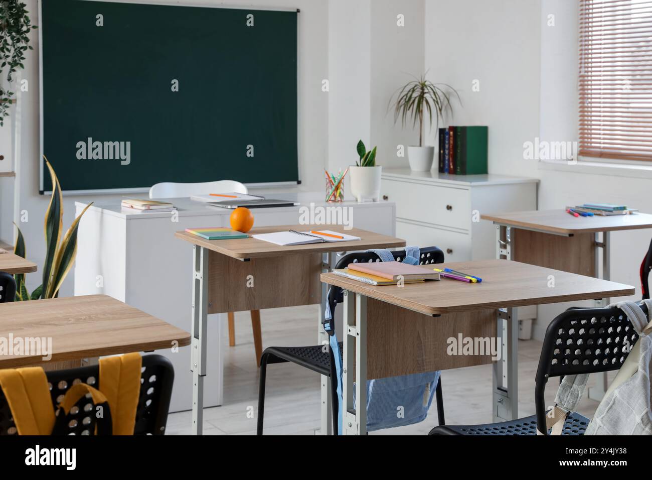 Interior of empty classroom with school desks and greenboard Stock ...