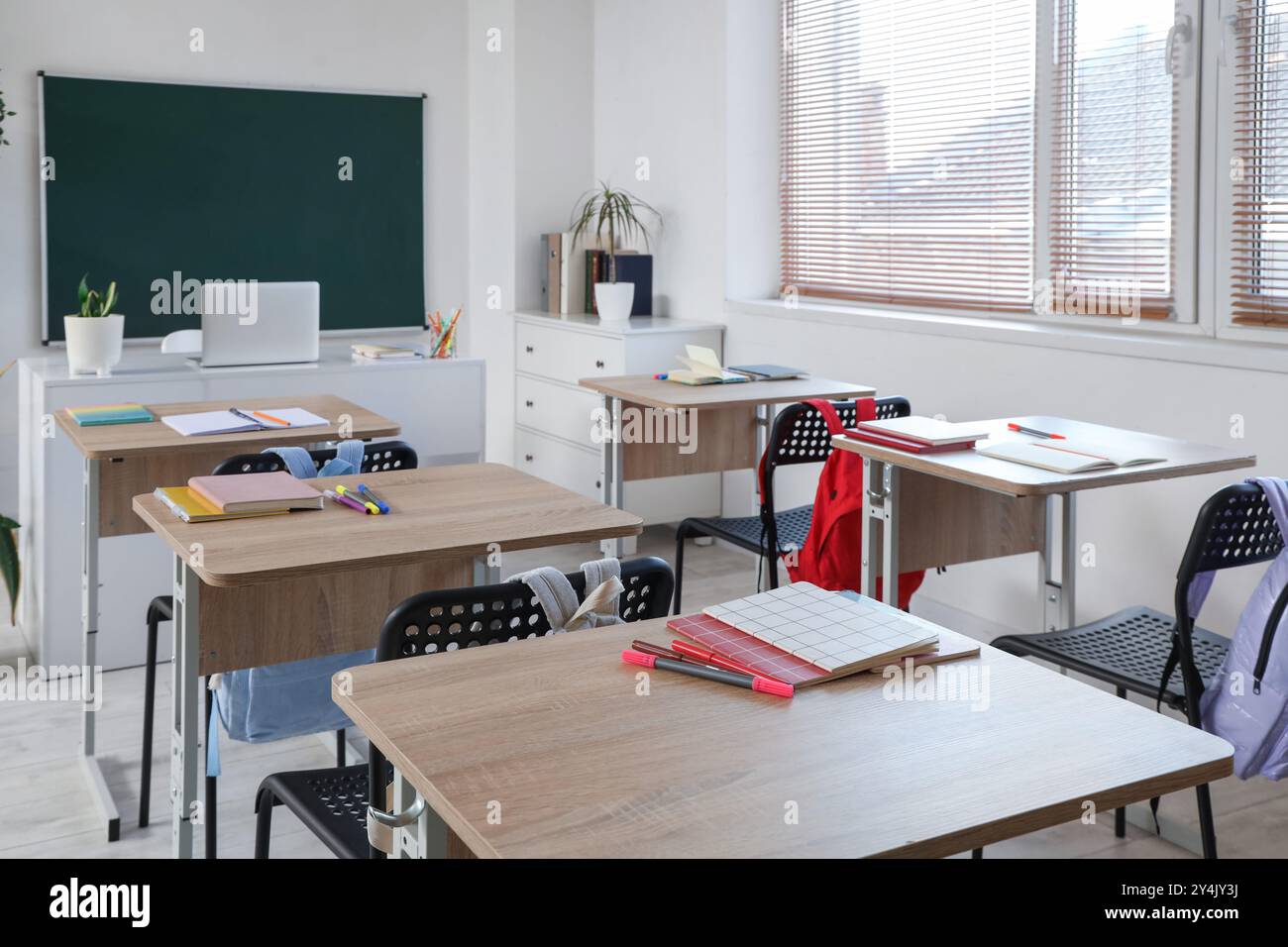 Interior of empty classroom with school desks and greenboard Stock ...