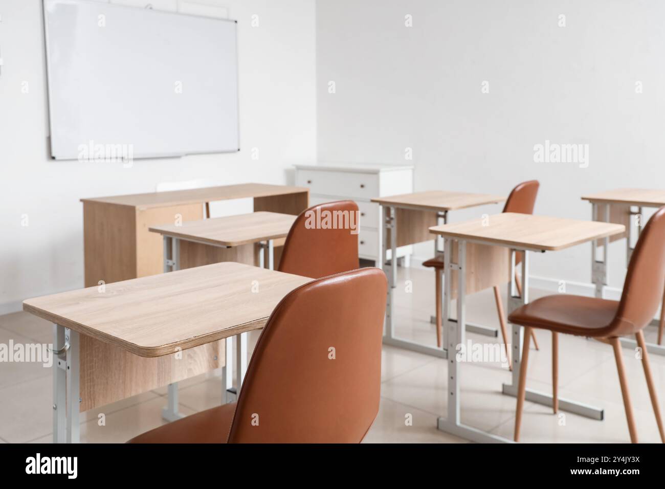 Interior of empty classroom with school desks and clean whiteboard ...