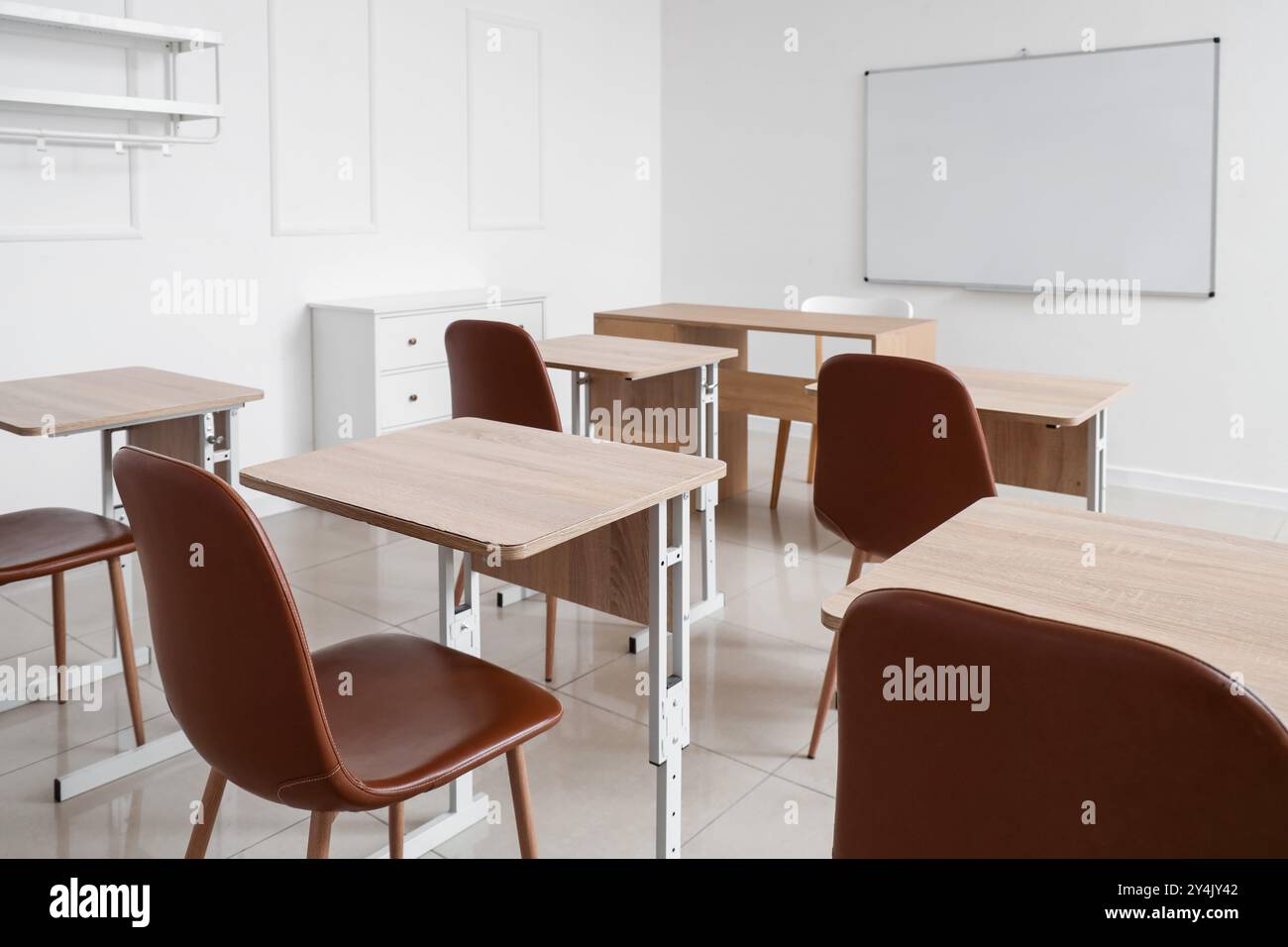 Interior of empty classroom with school desks and clean whiteboard ...