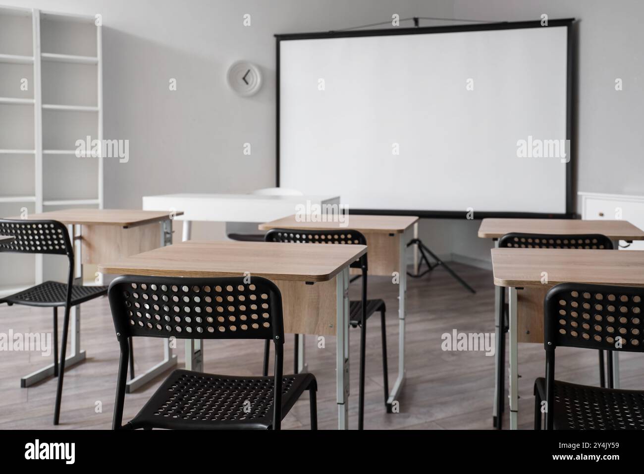 Interior of classroom with school desks and projector screen Stock ...