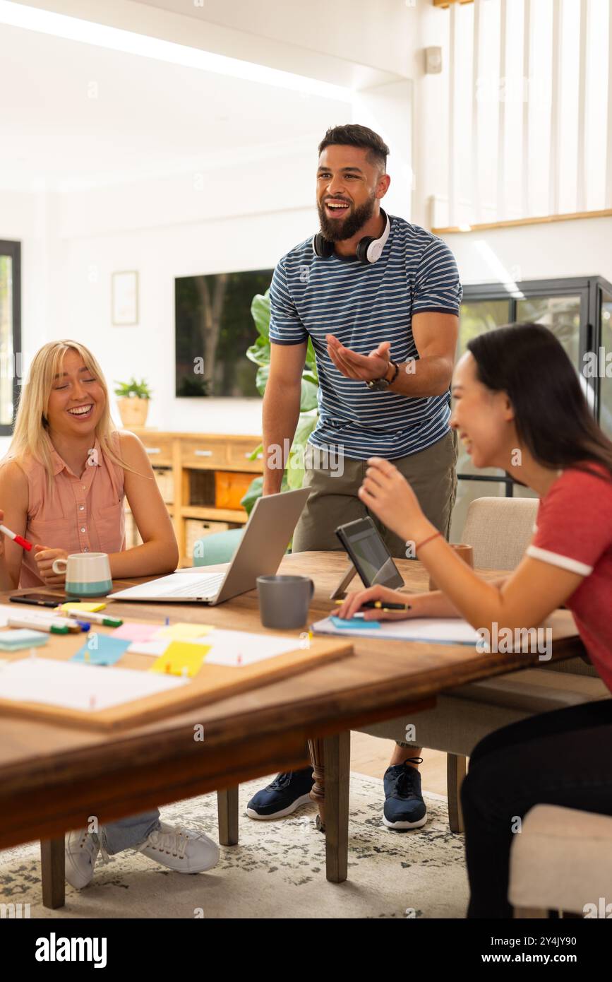 Start up business, collaborating on project, friends using laptop and tablet, brainstorming ...