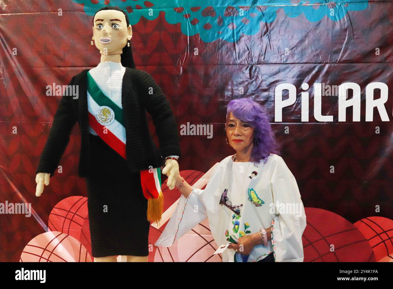 Mexico City, Mexico. 18th Sep, 2024. A woman poses with a life-size ...