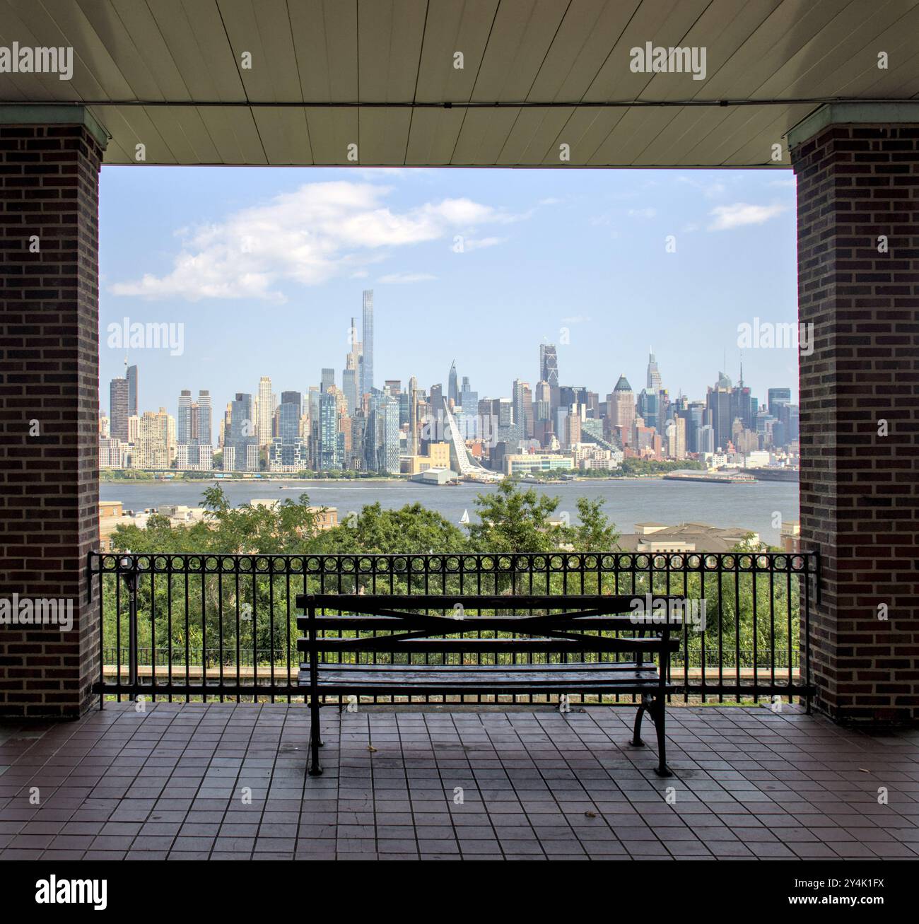 bench in a public park in west new york overlooking midtown manhattan ...
