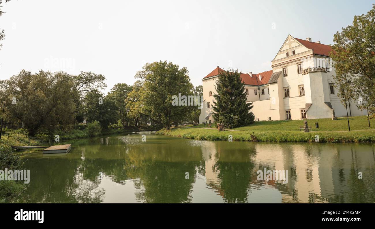 A picturesque view of a historic castle located by a tranquil riverbank ...