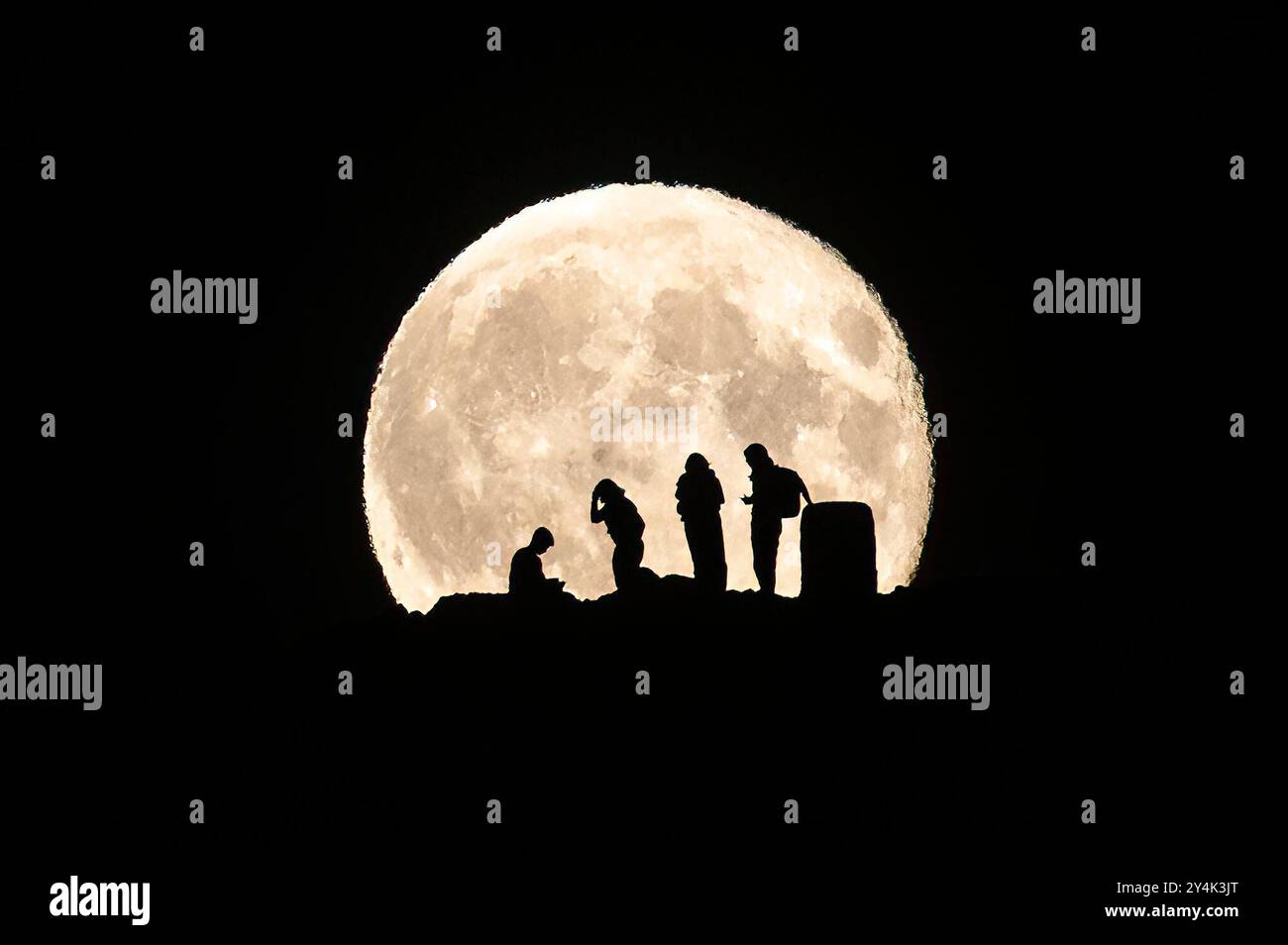 The Harvest moon rises over the top of Edinburgh's Arthur's seat with ...