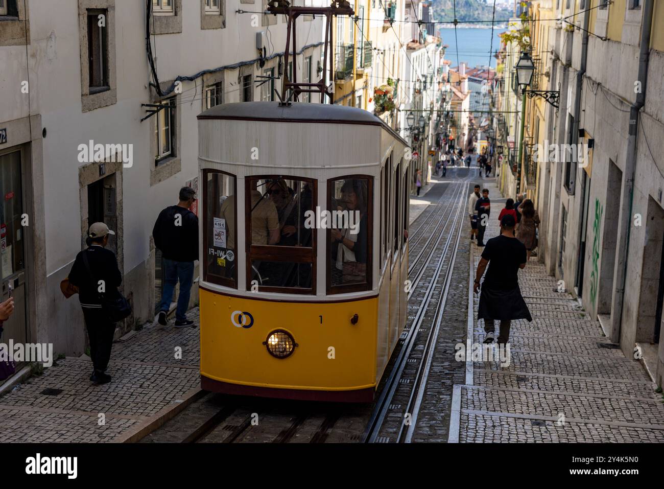 The Bica funicular transports riders up one of Lisbon's many steep ...