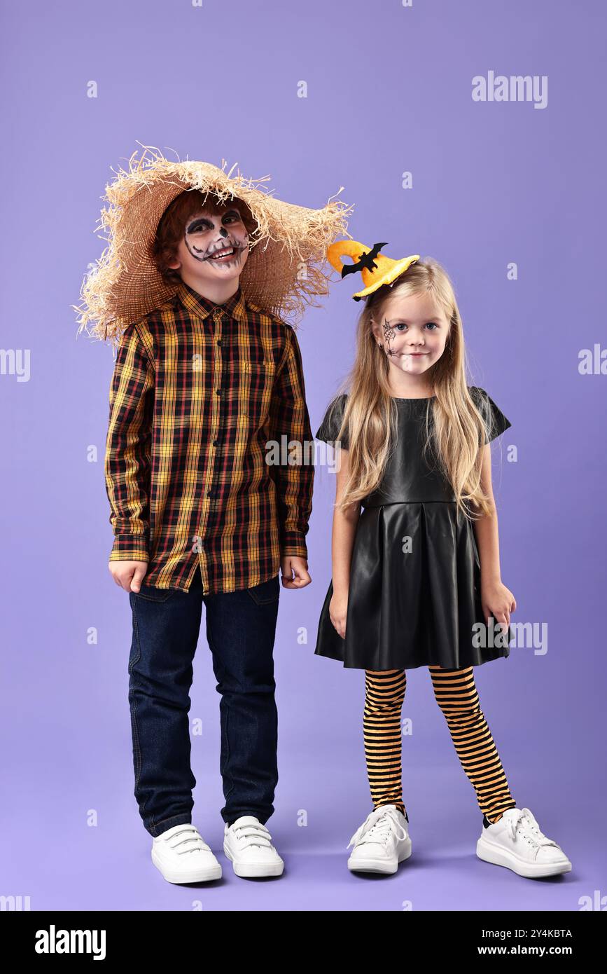 Cute children wearing costumes on violet background. Halloween ...