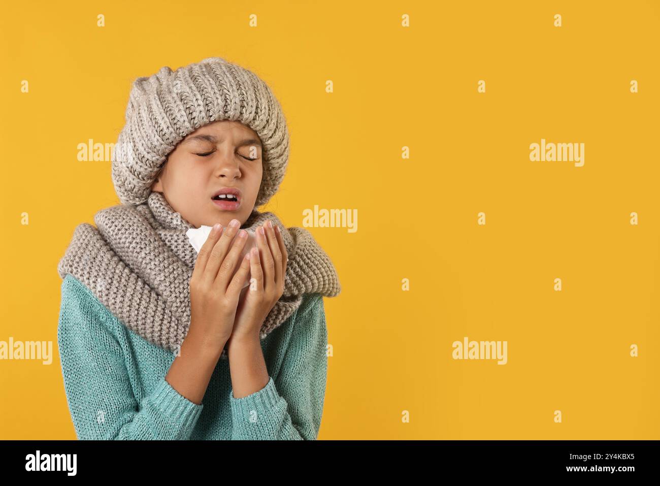 Cold symptom. Little girl with runny nose on orange background, space ...
