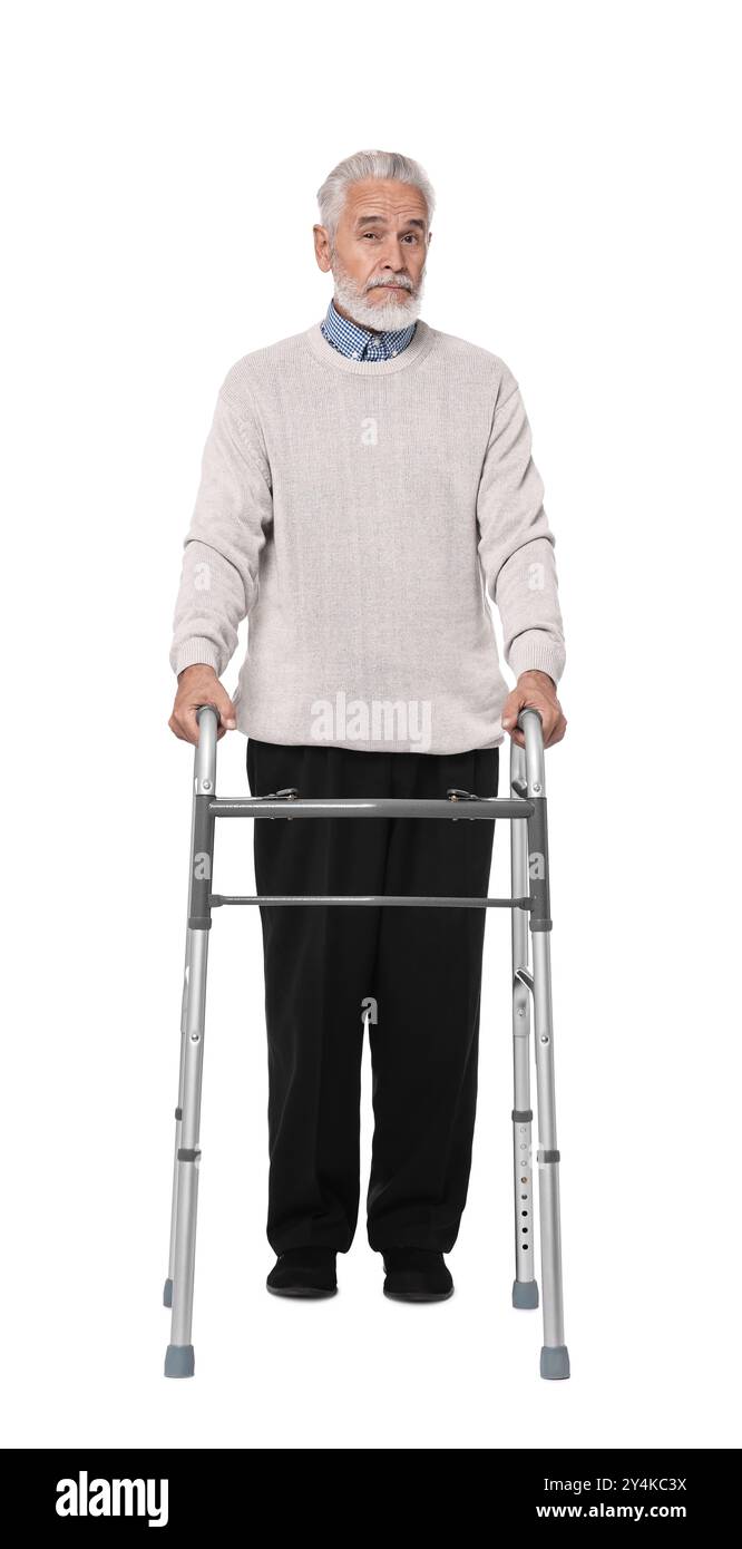 Senior man using walking frame on white background Stock Photo - Alamy