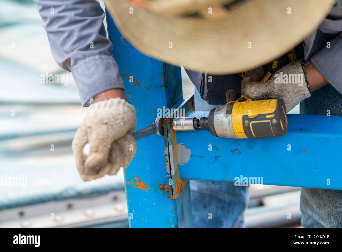 Worker use cordless block head screw and wrench remove nut of shelf in ...