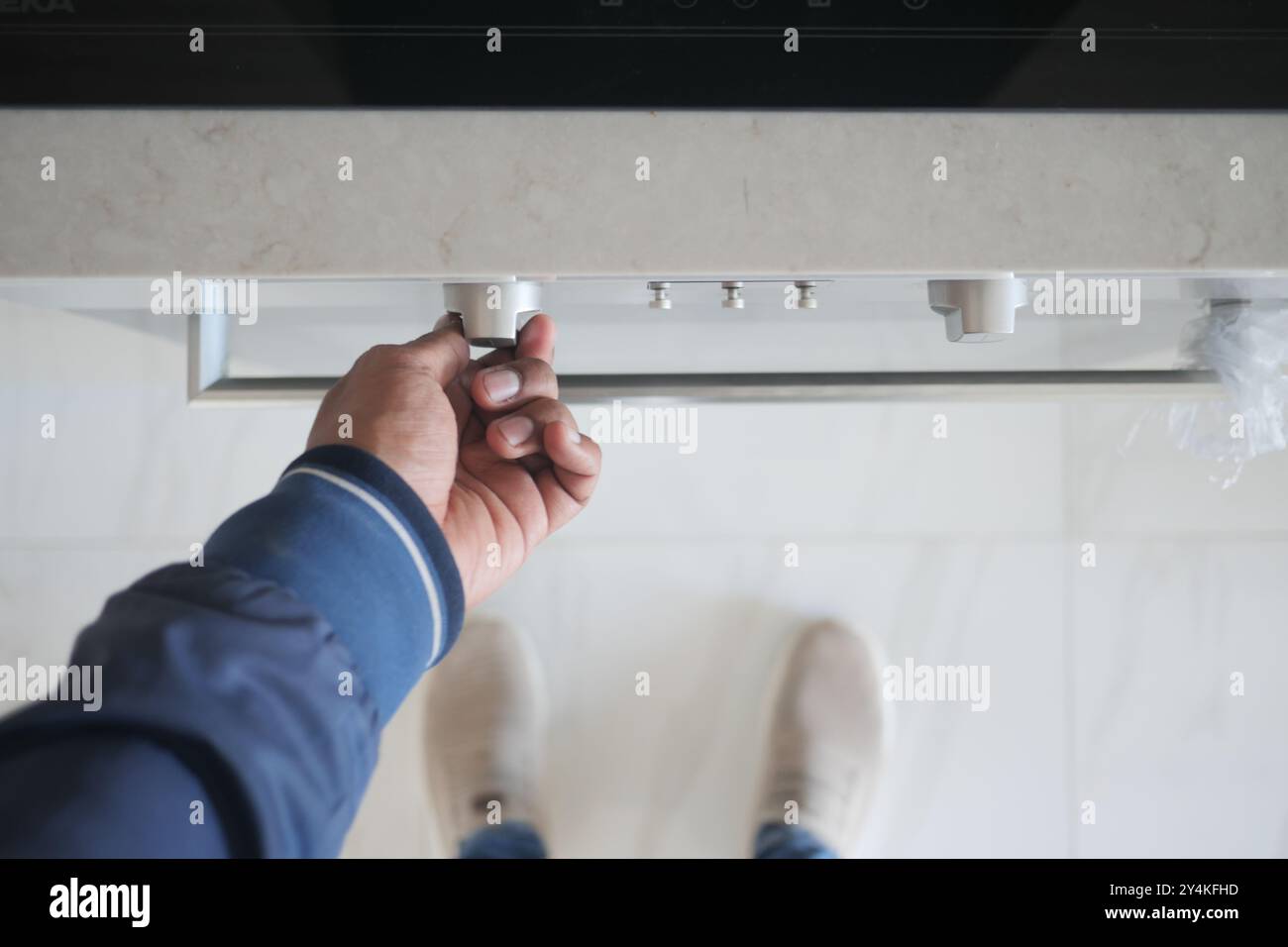 A hand is using a finger to activate the timer button on the control ...