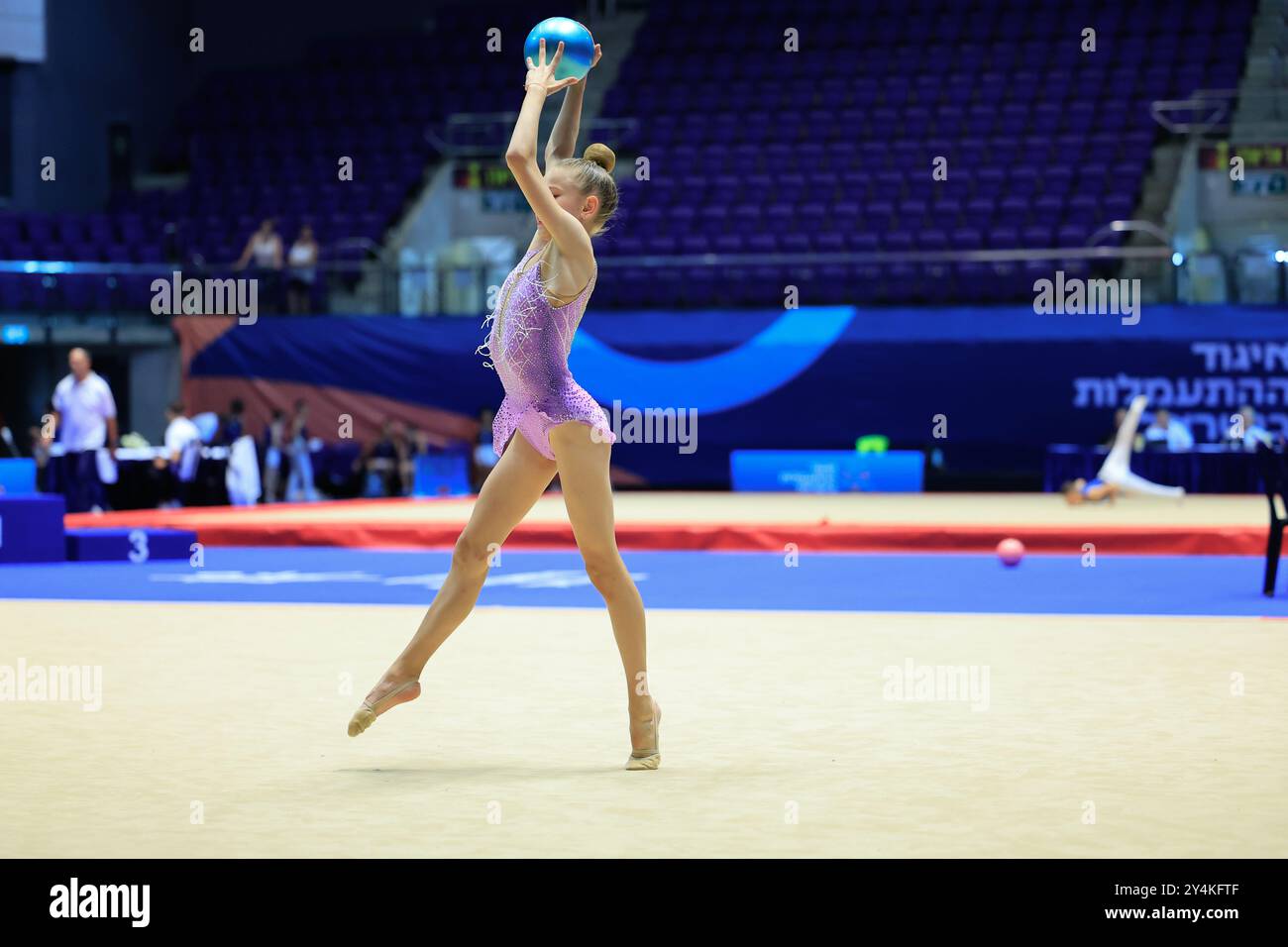 Female rhythmic gymnast showcasing her skills with a ball at a ...
