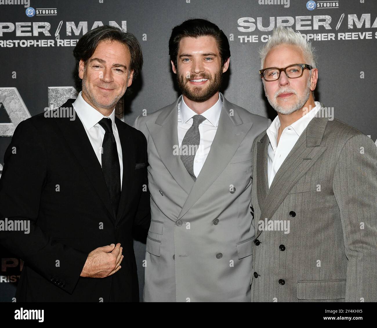 Peter Safran, left, David Corenswet and James Gunn attend the premiere ...