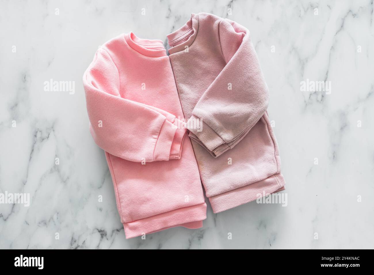 new vs old and used clothes, identical sweaters side by side one being ...