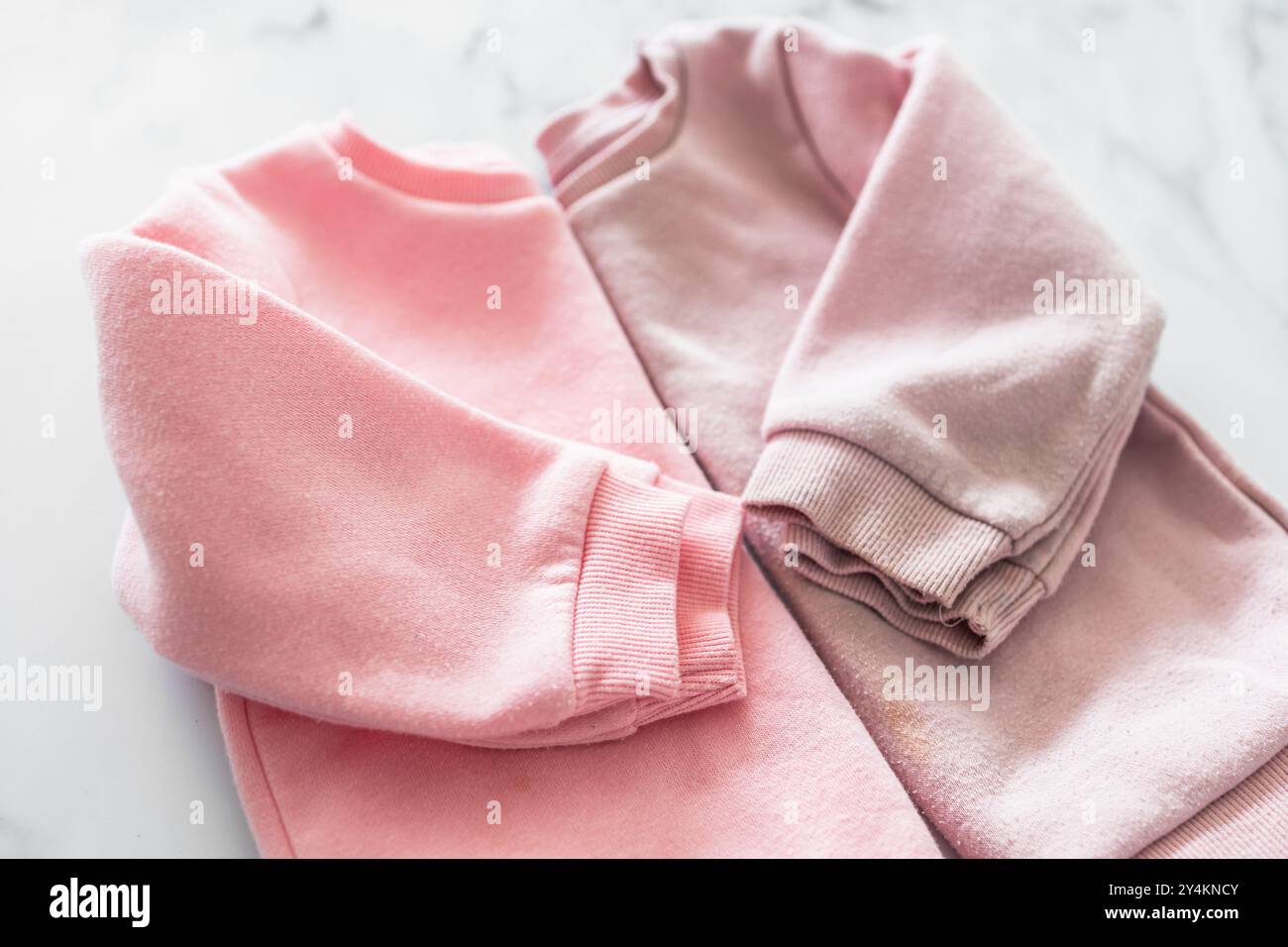 new vs old and used clothes, identical sweaters side by side one being ...