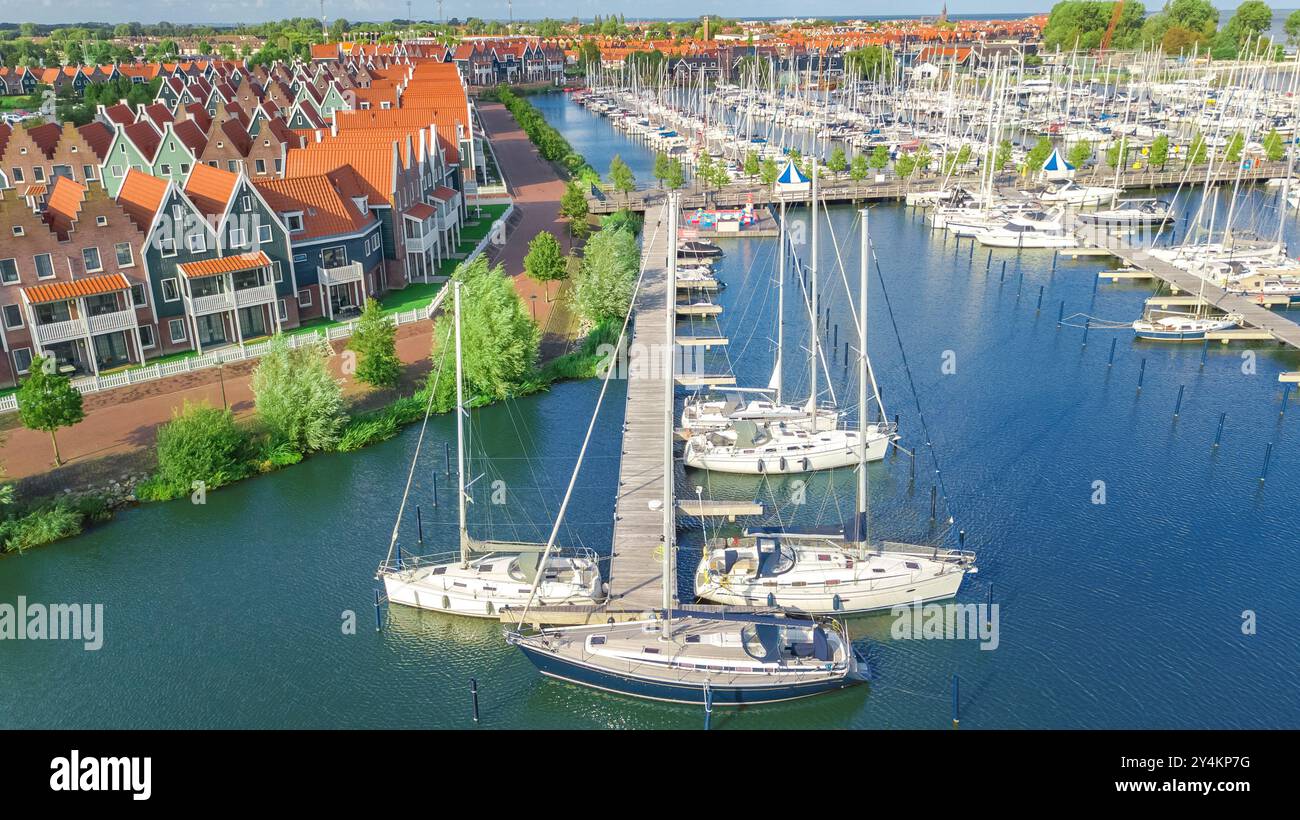 Aerial drone view of typical modern Dutch houses and marina in harbor ...