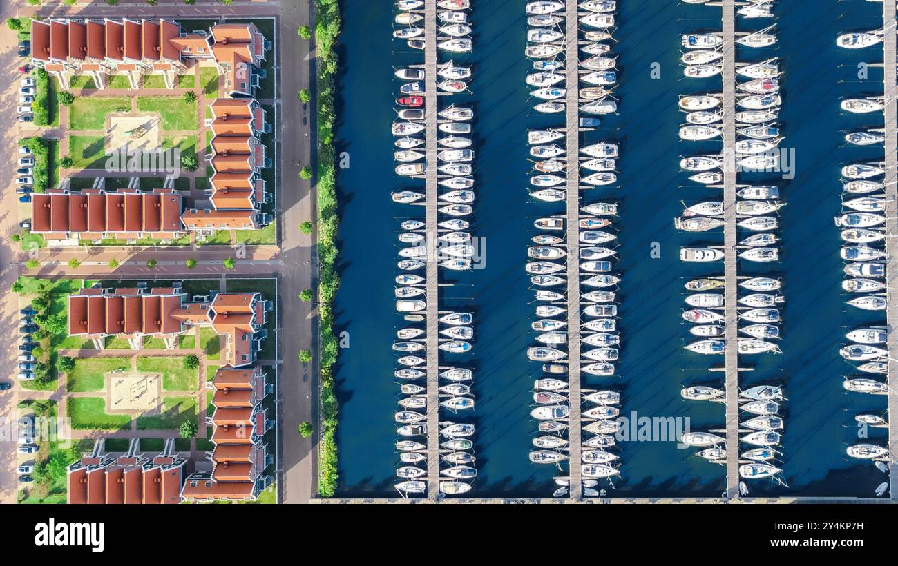 Aerial drone view of typical modern Dutch houses and marina in harbor ...
