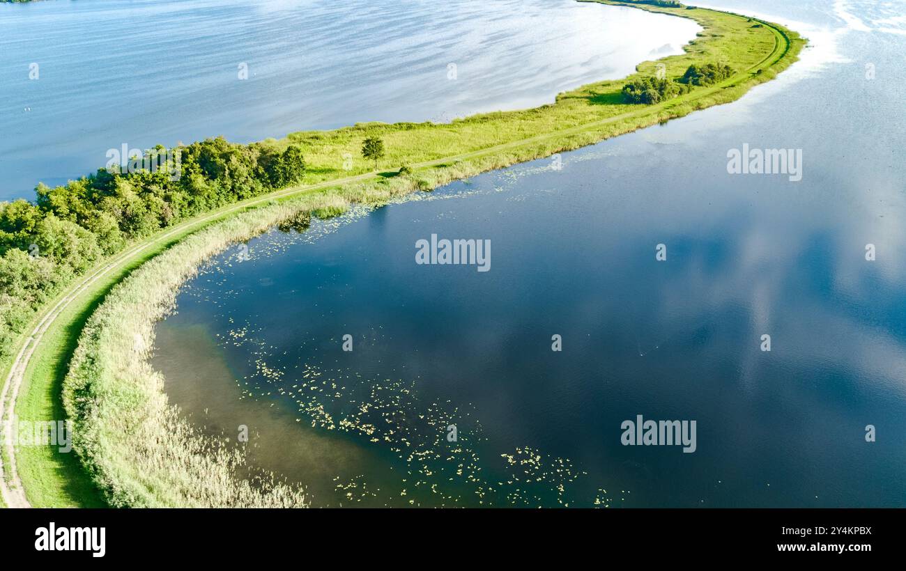 Aerial drone view of path on dam in polder water from above, landscape ...
