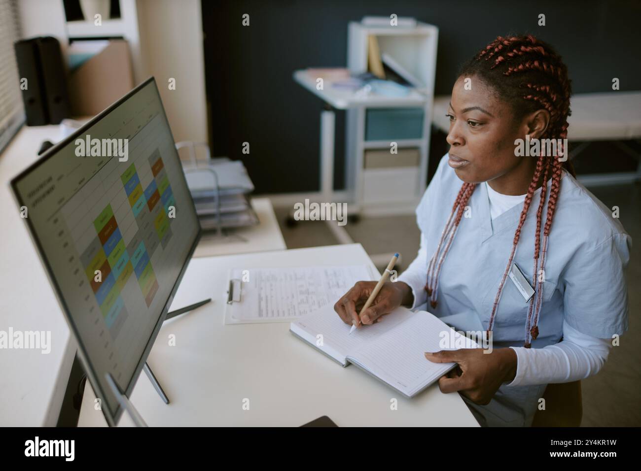 African American Nurse Reviewing Patient Documents Stock Photo - Alamy