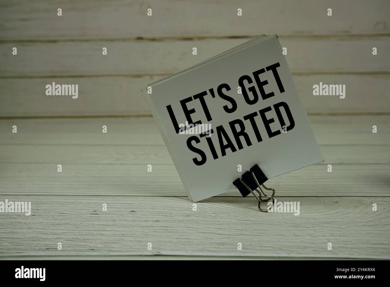Let's Get Started text message write on sticky note on wooden ...