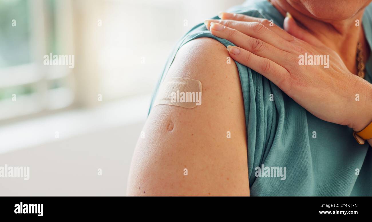 Bandage, patient and arm of woman with vaccine, healthcare and immune ...