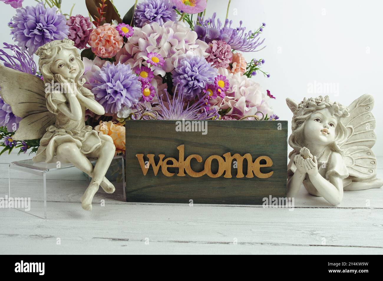 Welcome sign with flowers bouquet and angel statues home decorations ...