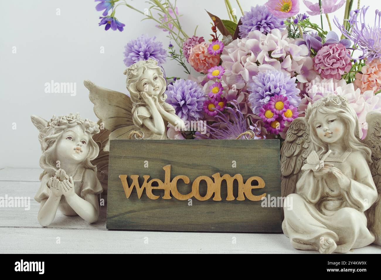 Welcome sign with flowers bouquet and angel statues home decorations ...