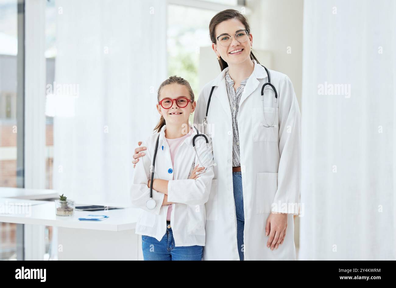 Portrait, doctor and girl with smile for career day in hospital with ...