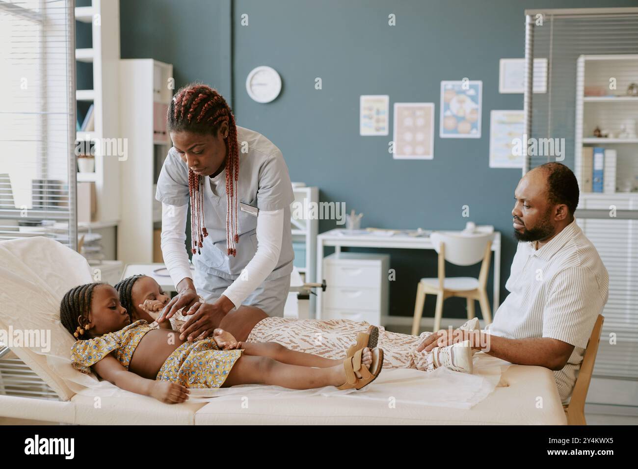 Caring Nurse Examining Child in Pediatric Clinic Room Stock Photo - Alamy