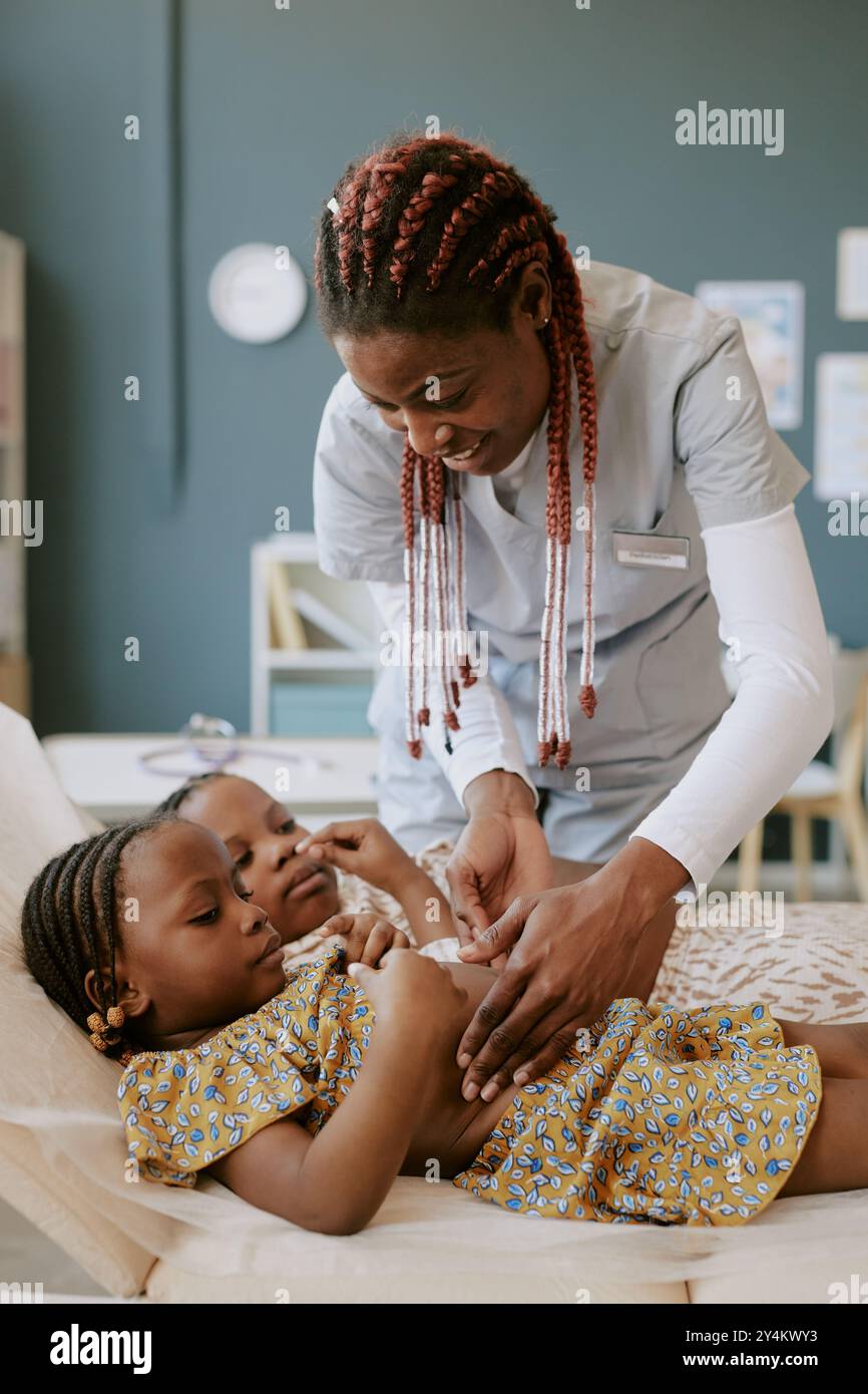 Nurse Treating Young Children in Medical Facility Stock Photo - Alamy