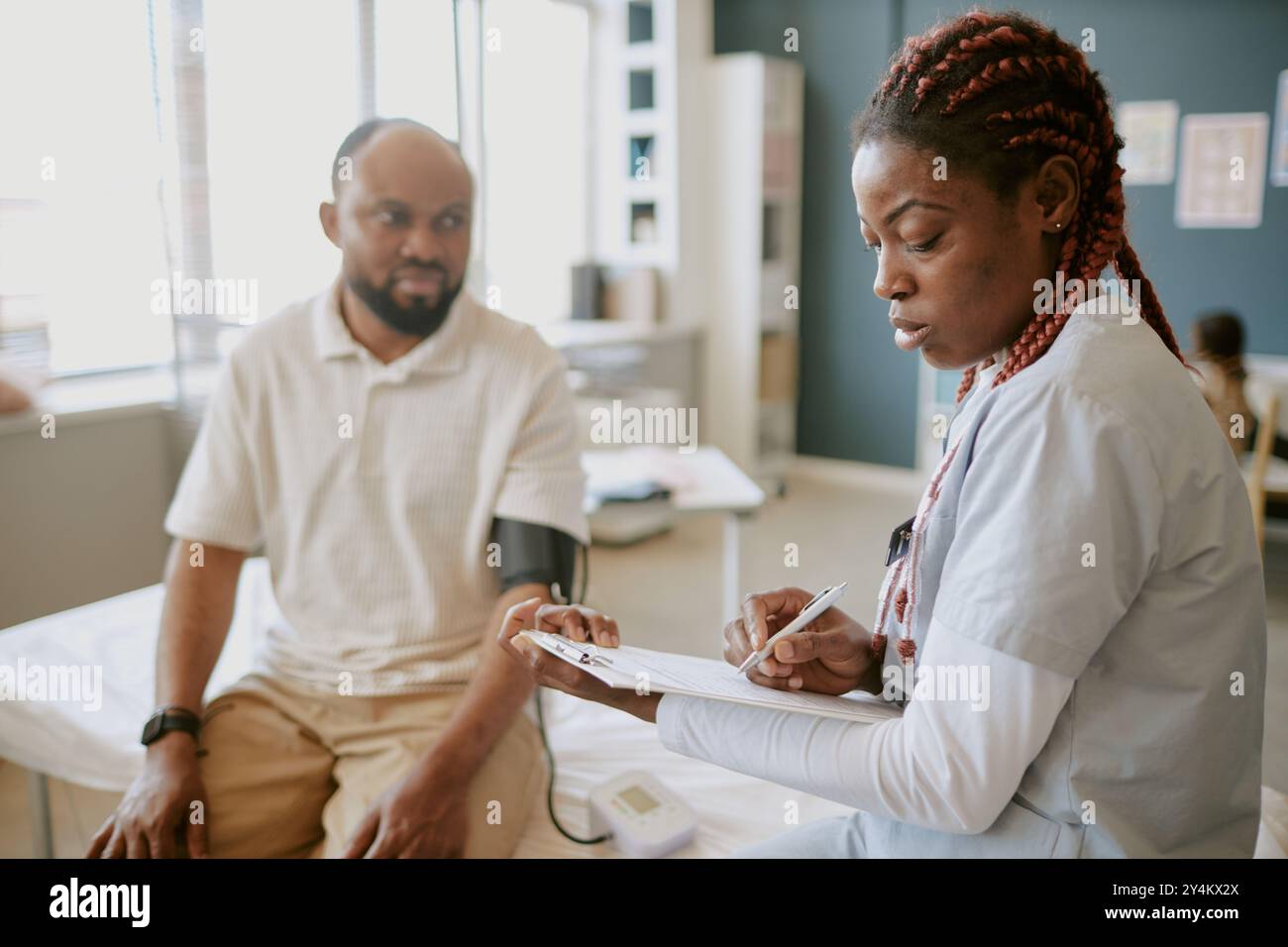 African American Doctor Writing Notes During Medical Checkup Stock ...