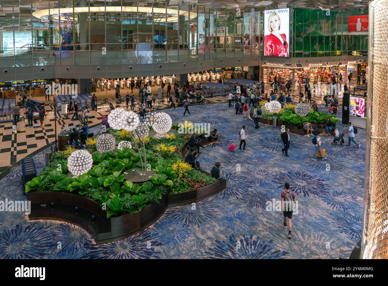 This is the departure area with shops and restaurants in Changi Airport ...