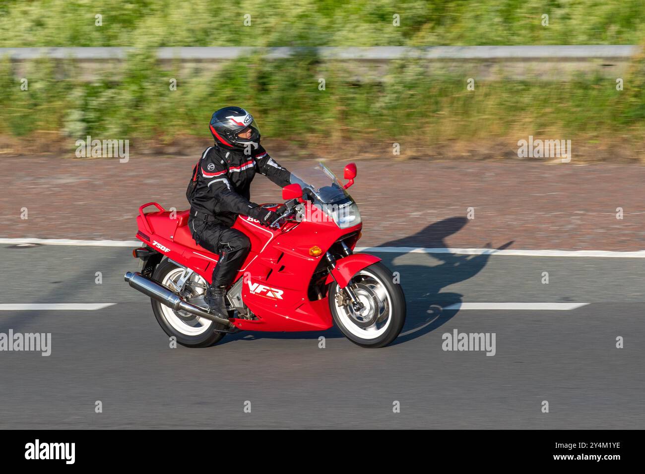 Red Honda VFR 750F motorcycle road bike. Sporty sport tourer, and is powered by a 750 cc V4 ...