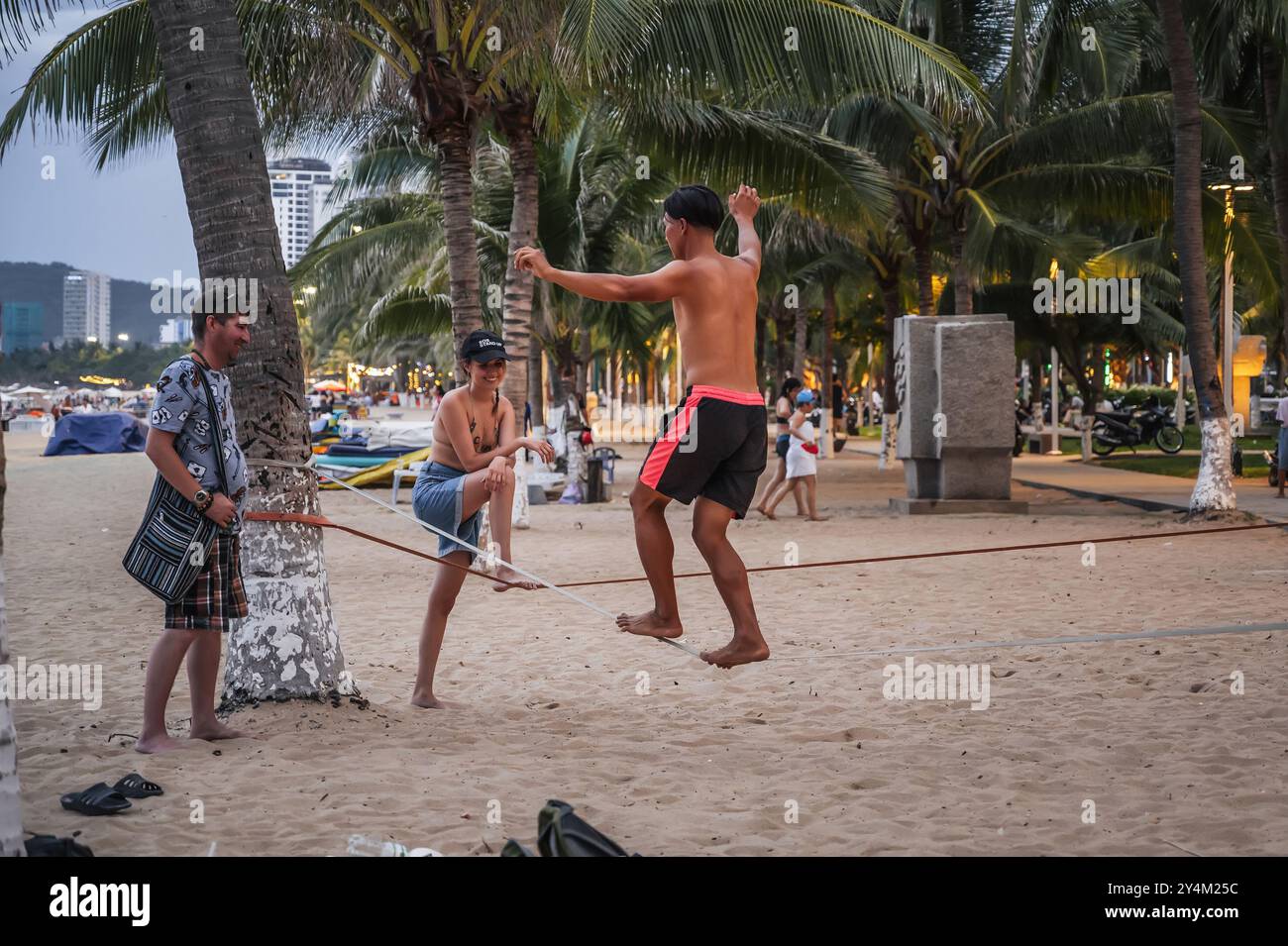 People practice slackline tightrope walking on a beach in Vietnam in ...