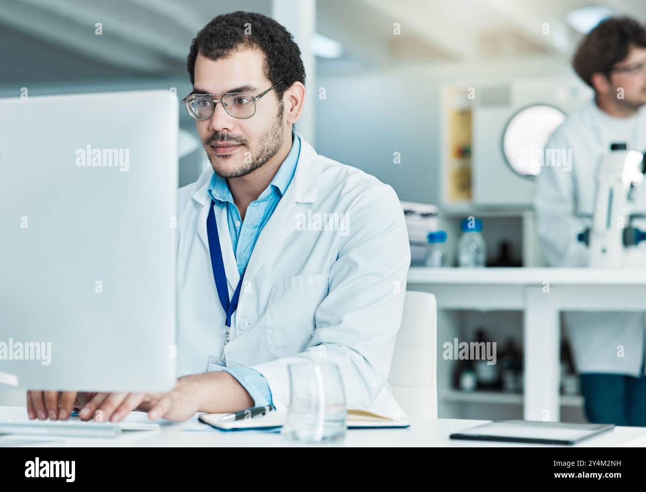 Busy doctor working laboratory typing hi-res stock photography and ...