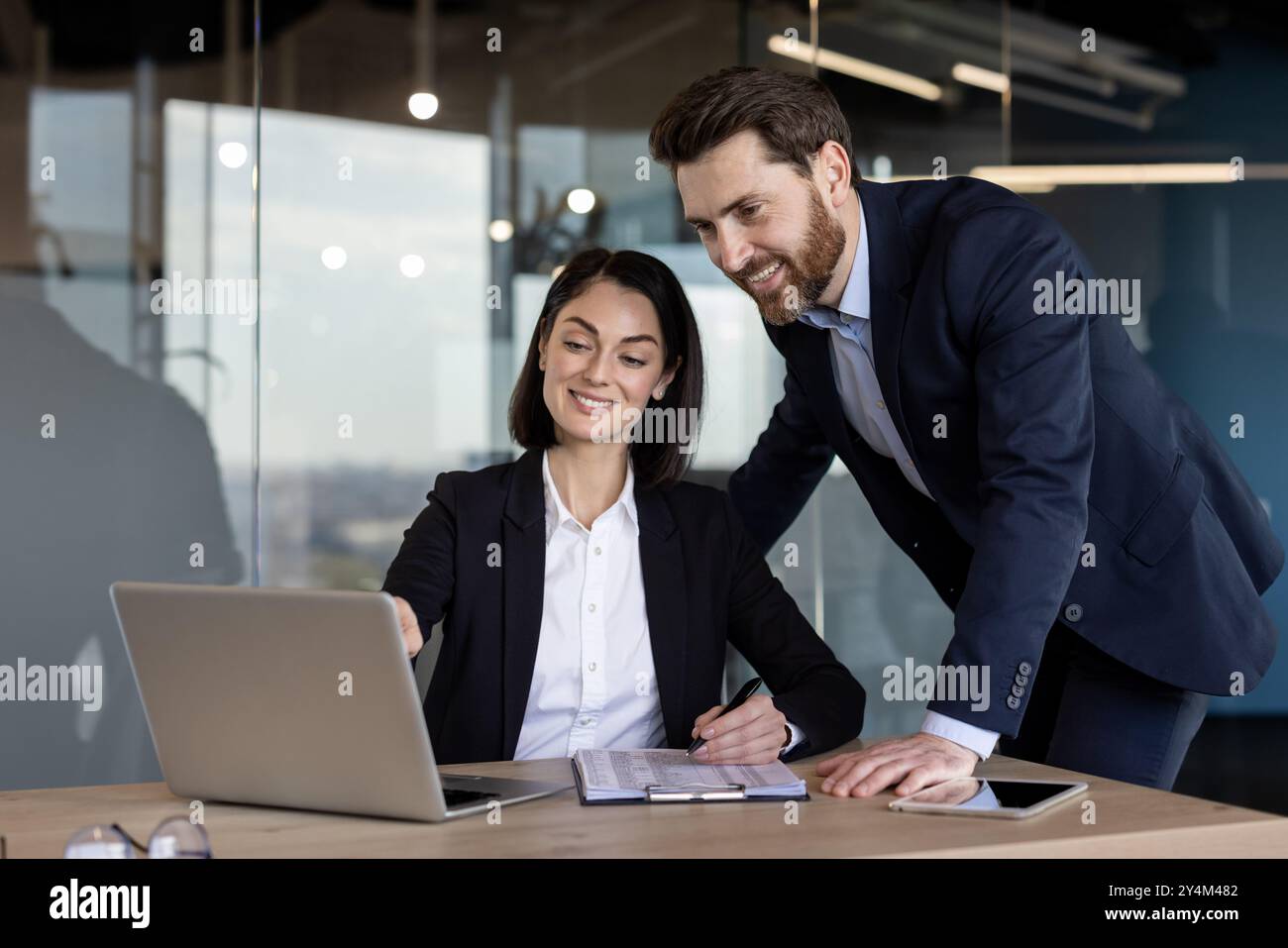 Business professionals engaging in teamwork at office. Smiling ...