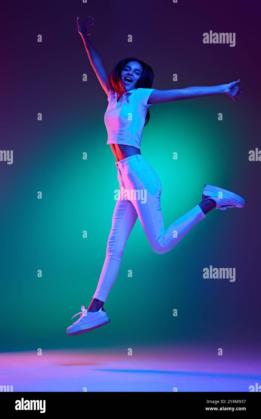 Full length photo of attractive young girl, jumping of success raising ...
