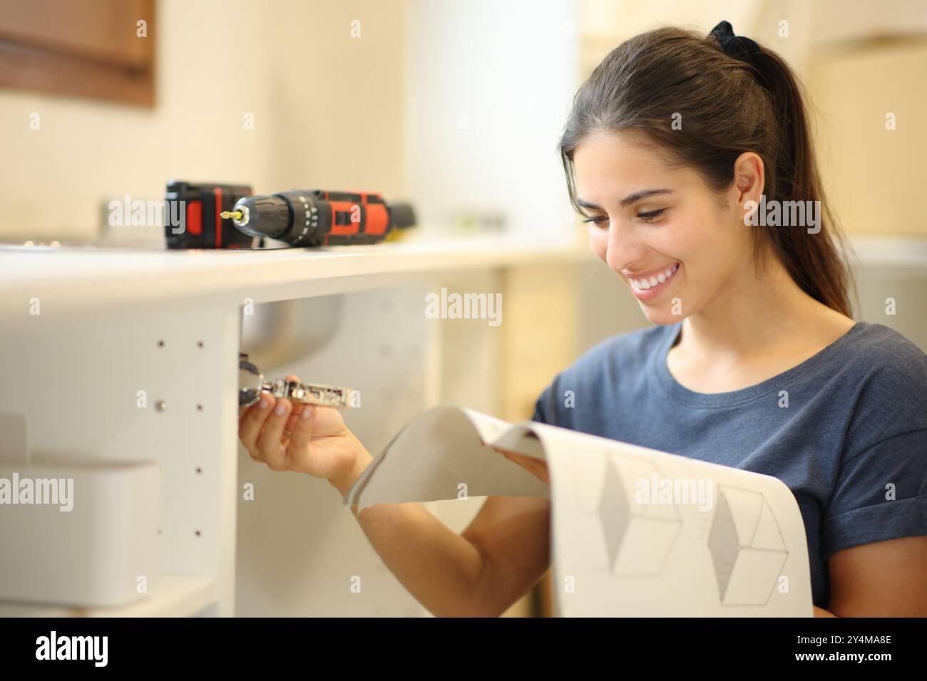 Happy tenant checking kitchen furniture installation manual reforming ...
