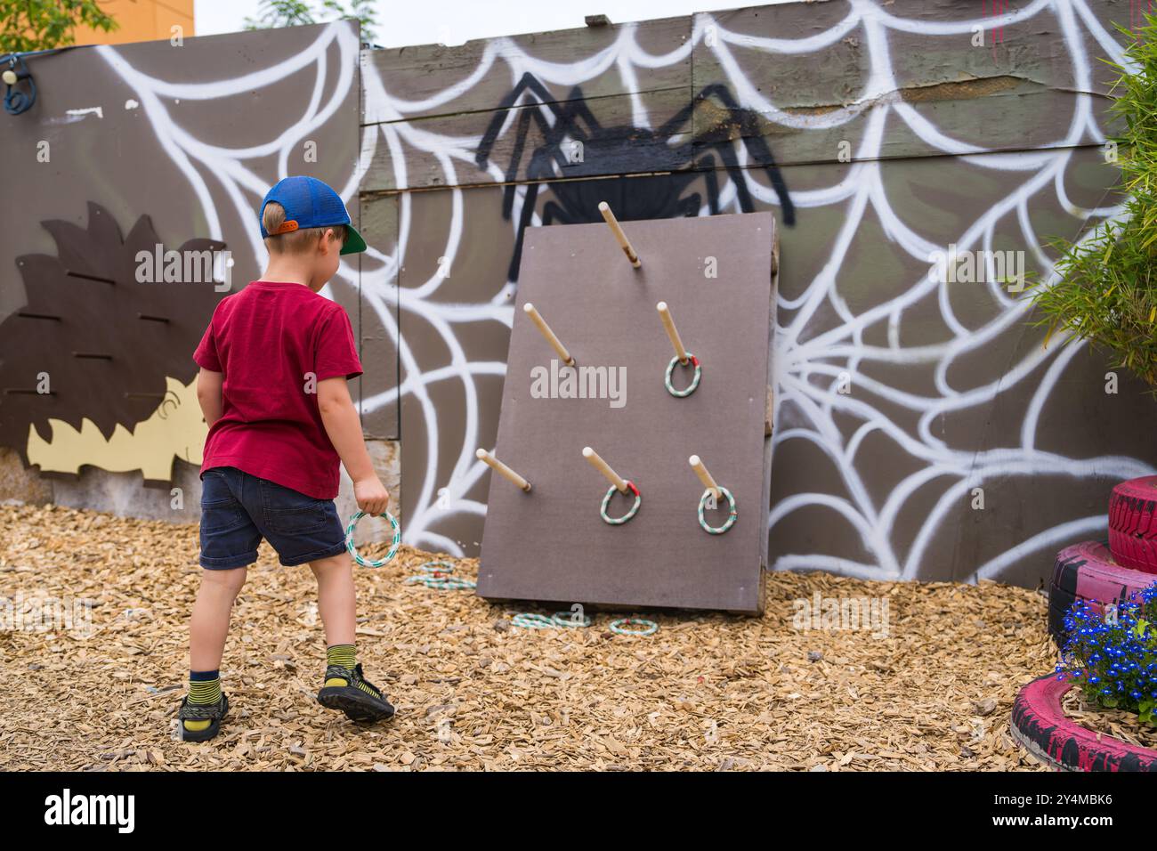 Little boy is playing in playroom. Throwing mugs. Playroom in form of ...