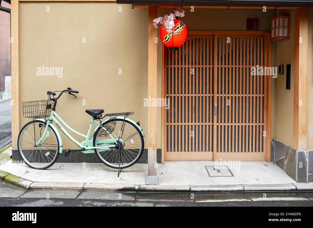 Still life with a bicycle standing in front of a traditional house in ...